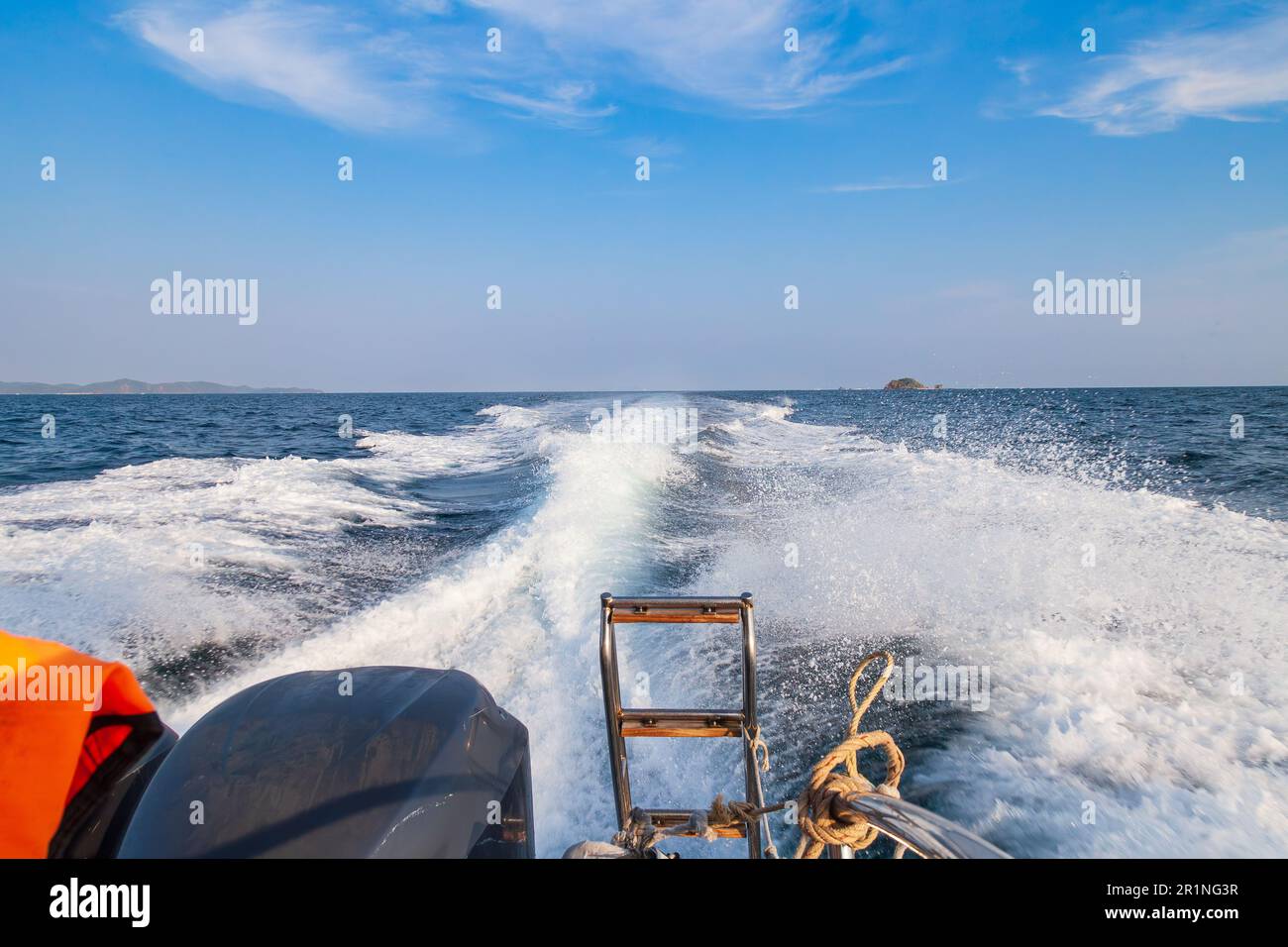 Waves from a speedboat on the blue sea with splashes and a trail from a ...