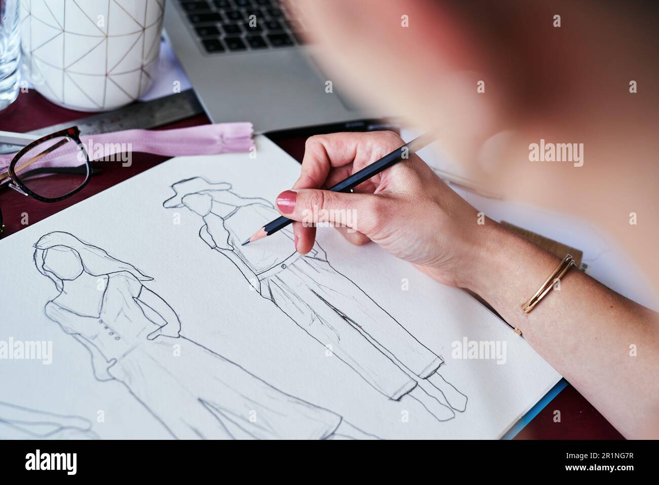 Designing for the modern woman. a fashion designer working on new ...