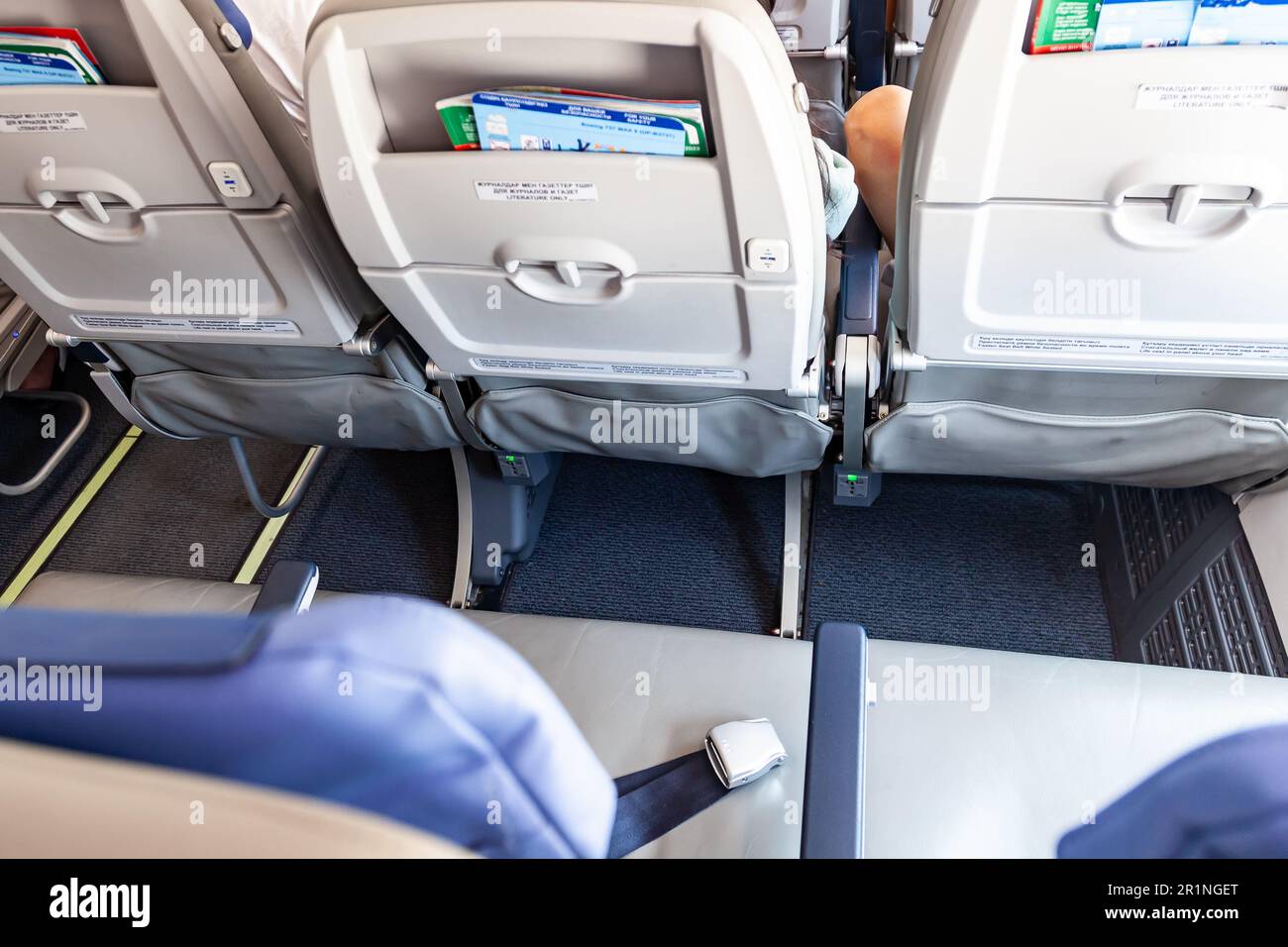 Economy class seats in the aircraft cabin with a small distance between ...