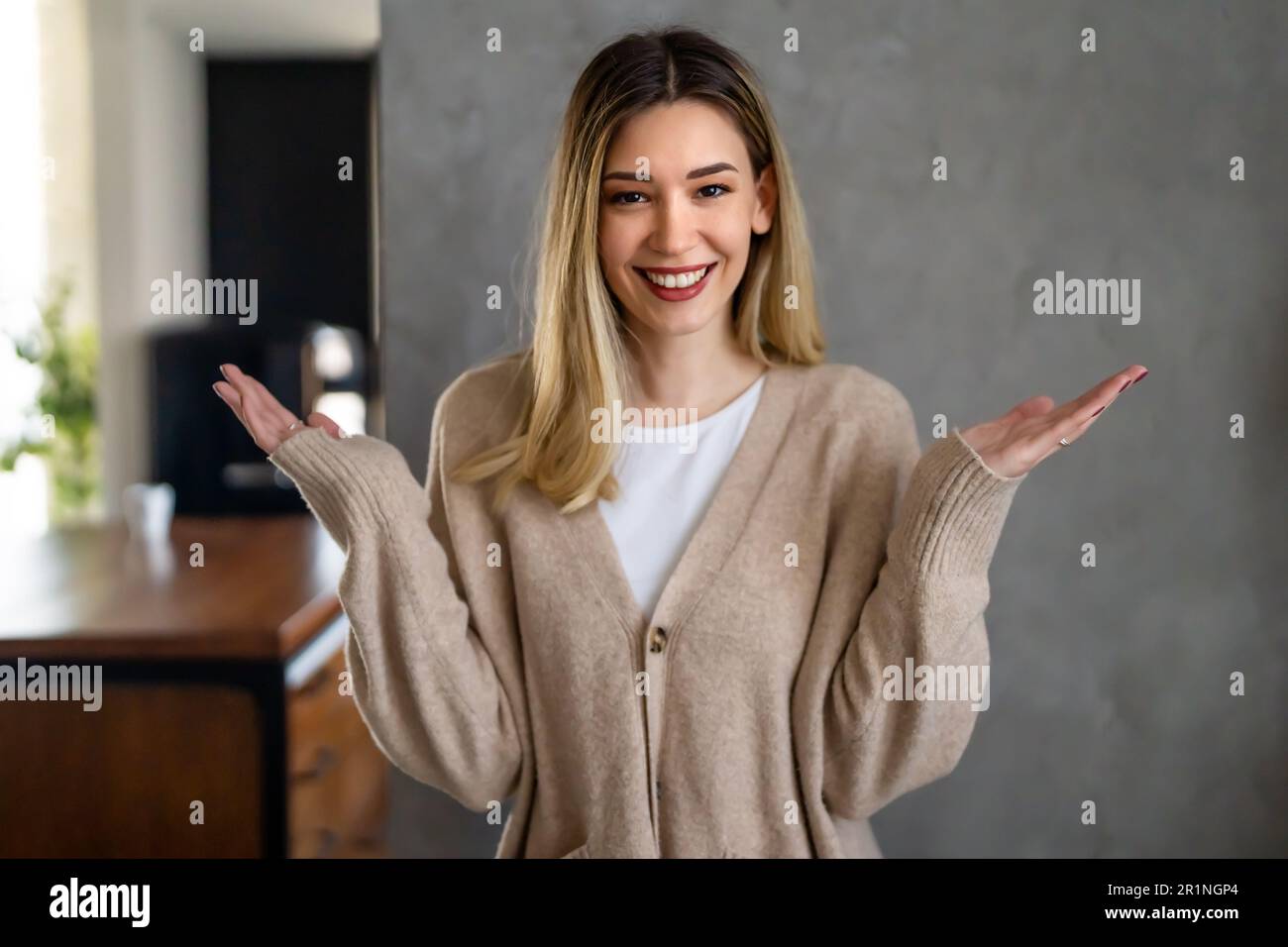 Woman making scale with her arms wide open. Smiling woman does not know ...