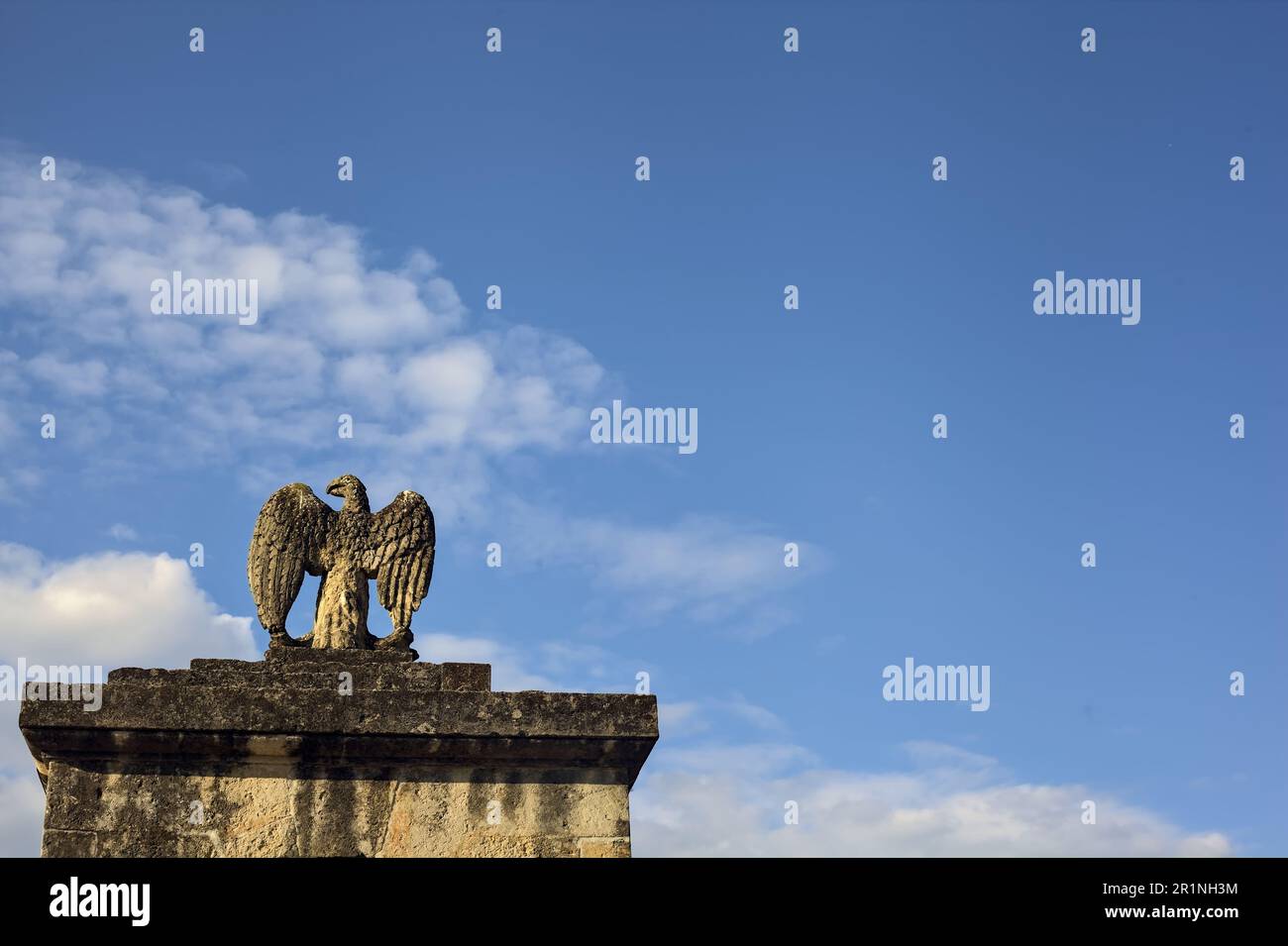 Eagle statue on a gate with a blue sky as background at sunset Stock ...