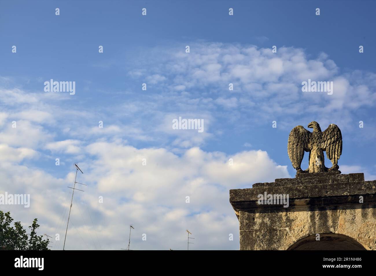 Eagle statue on a gate with a blue sky as background at sunset Stock ...