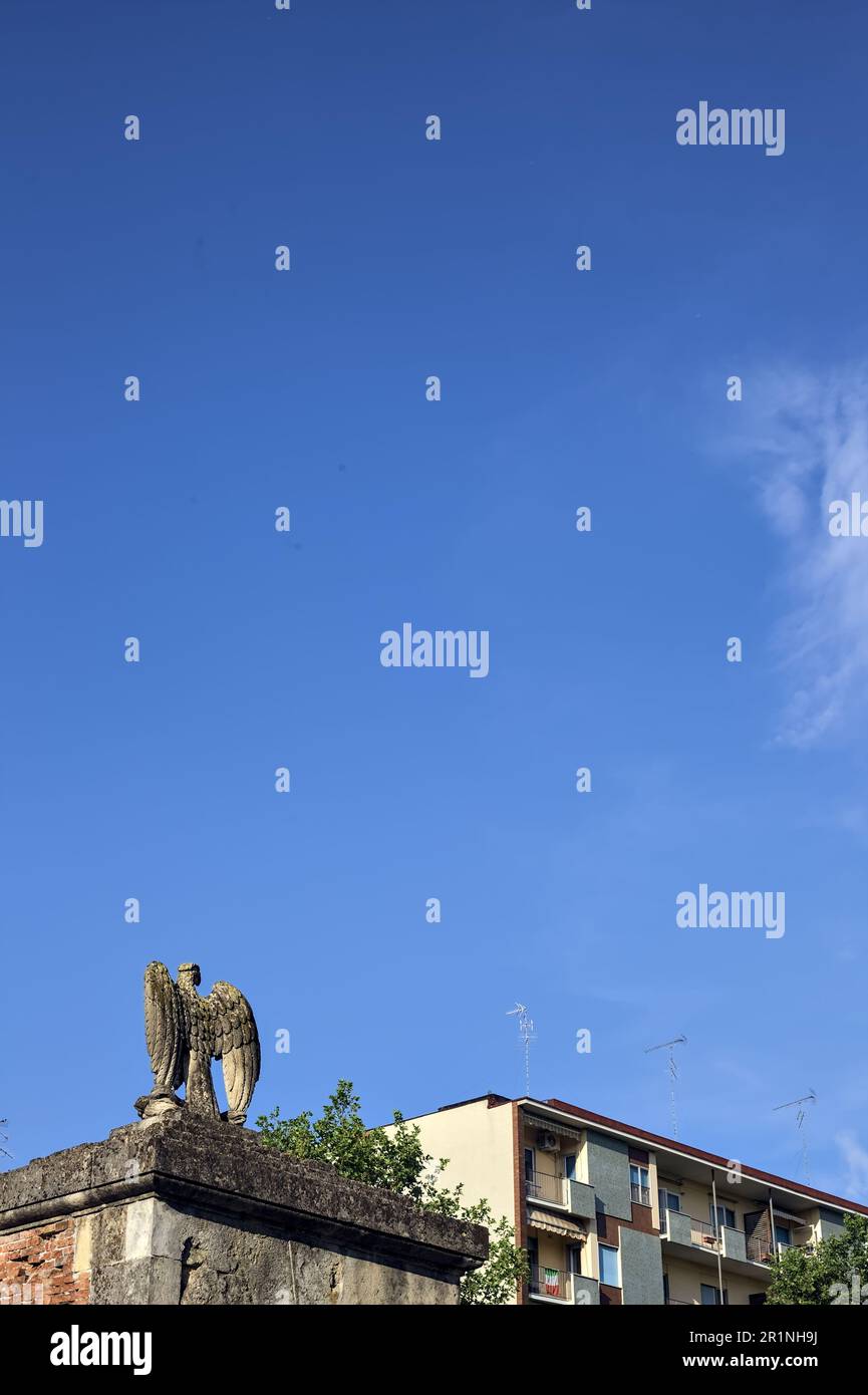 Eagle statue on a gate with a blue sky as background at sunset Stock ...