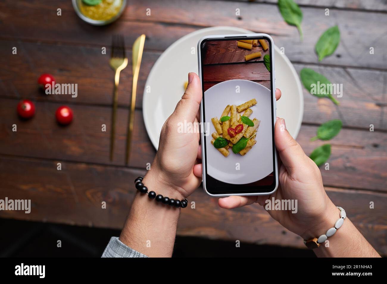 Top view of photographer making photo of food on mobile phone for food ...