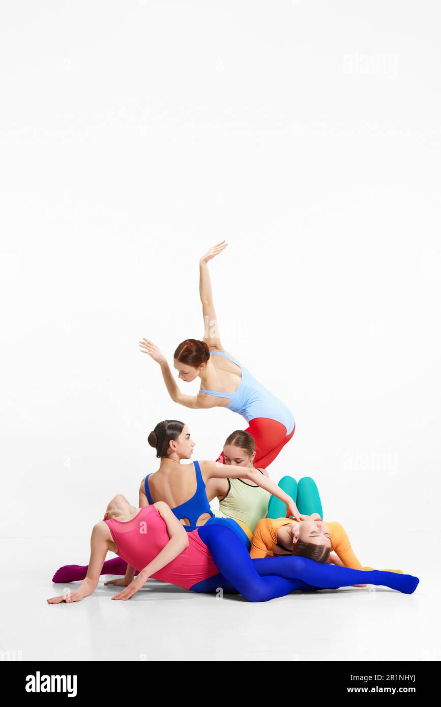 Vertical image of artisitc young girls, ballet dancers in multicolored ...