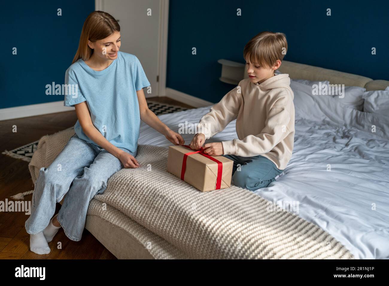 Happy kid son unwrapping gift box feeling excited getting present from ...