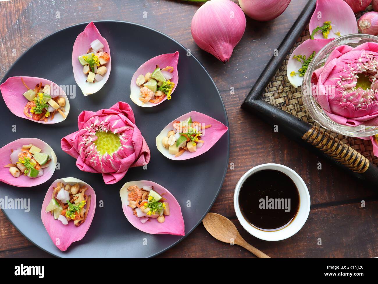 Miang Kham Bua Luang - Lotus leaf wrapped with coconut flakes, chopped ...