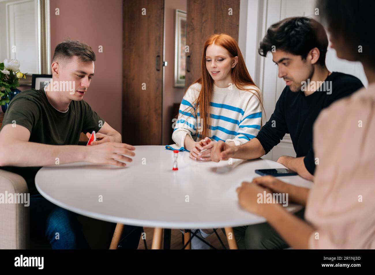 Best multiethnic friends having fun with charades cards play, enjoying ...