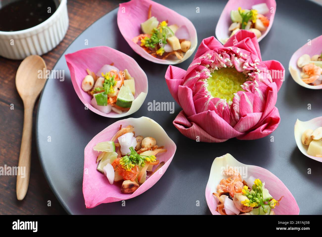 Miang Kham Bua Luang - Lotus leaf wrapped with coconut flakes, chopped ...