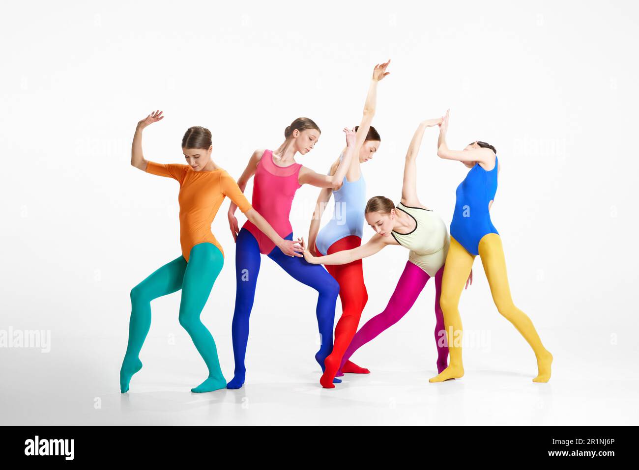 Expressive movements. Young stylish girls, ballet dancers in bright ...