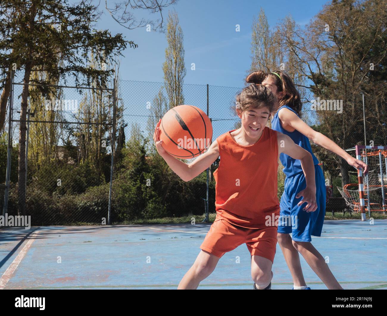 Basketball player dribbling another player in an outdoor game Stock ...