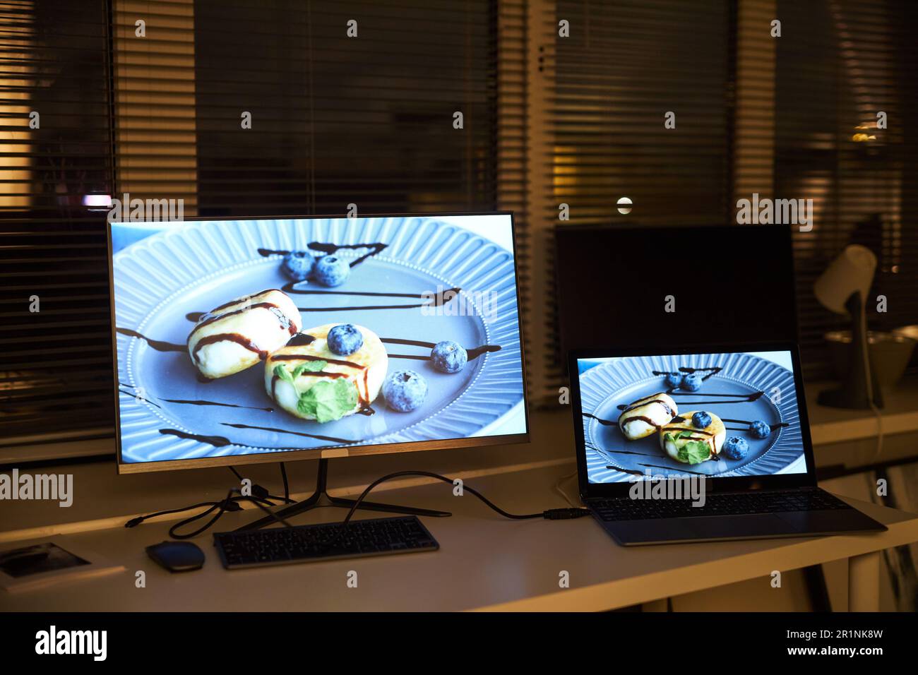 Computer monitors with professional photos on screen standing on ...