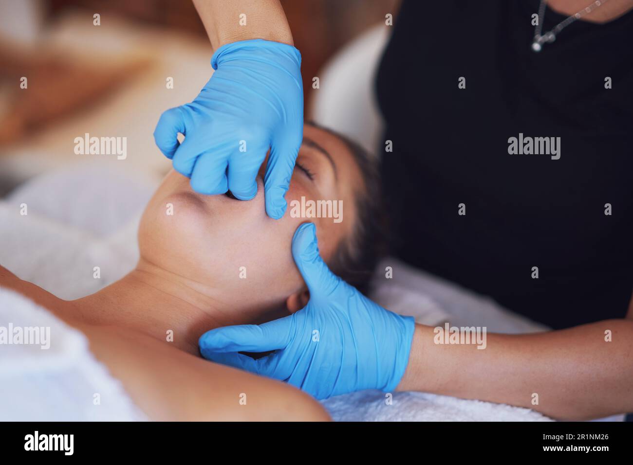 Woman having mouth massage in blue gloves Stock Photo - Alamy