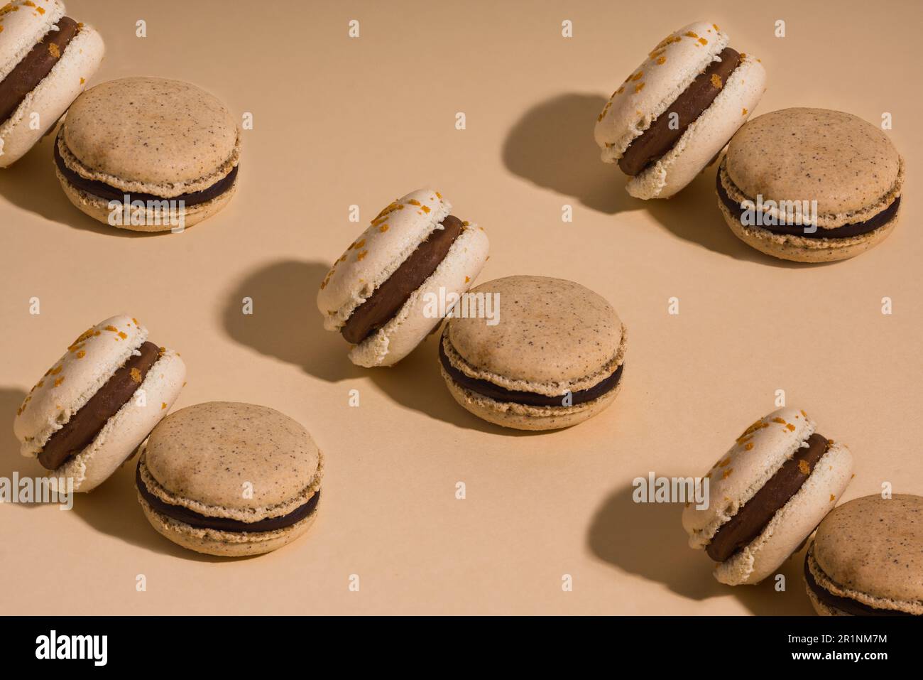 Pattern of a beige french macaroons with a shadow Stock Photo - Alamy