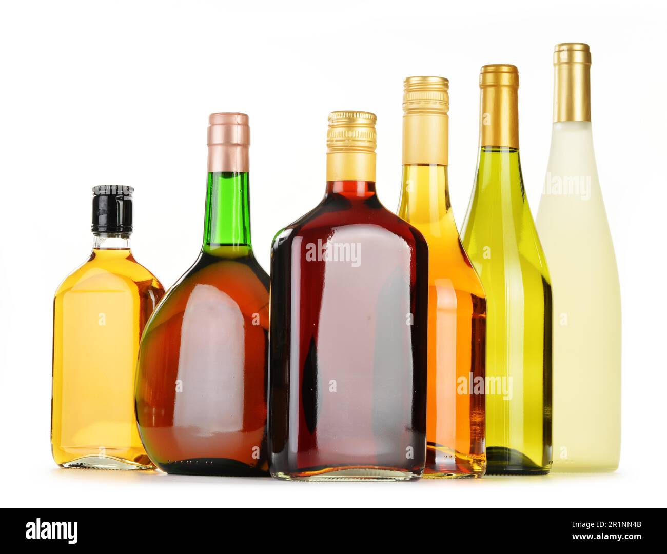 Bottles of assorted alcoholic beverages isolated on white background ...