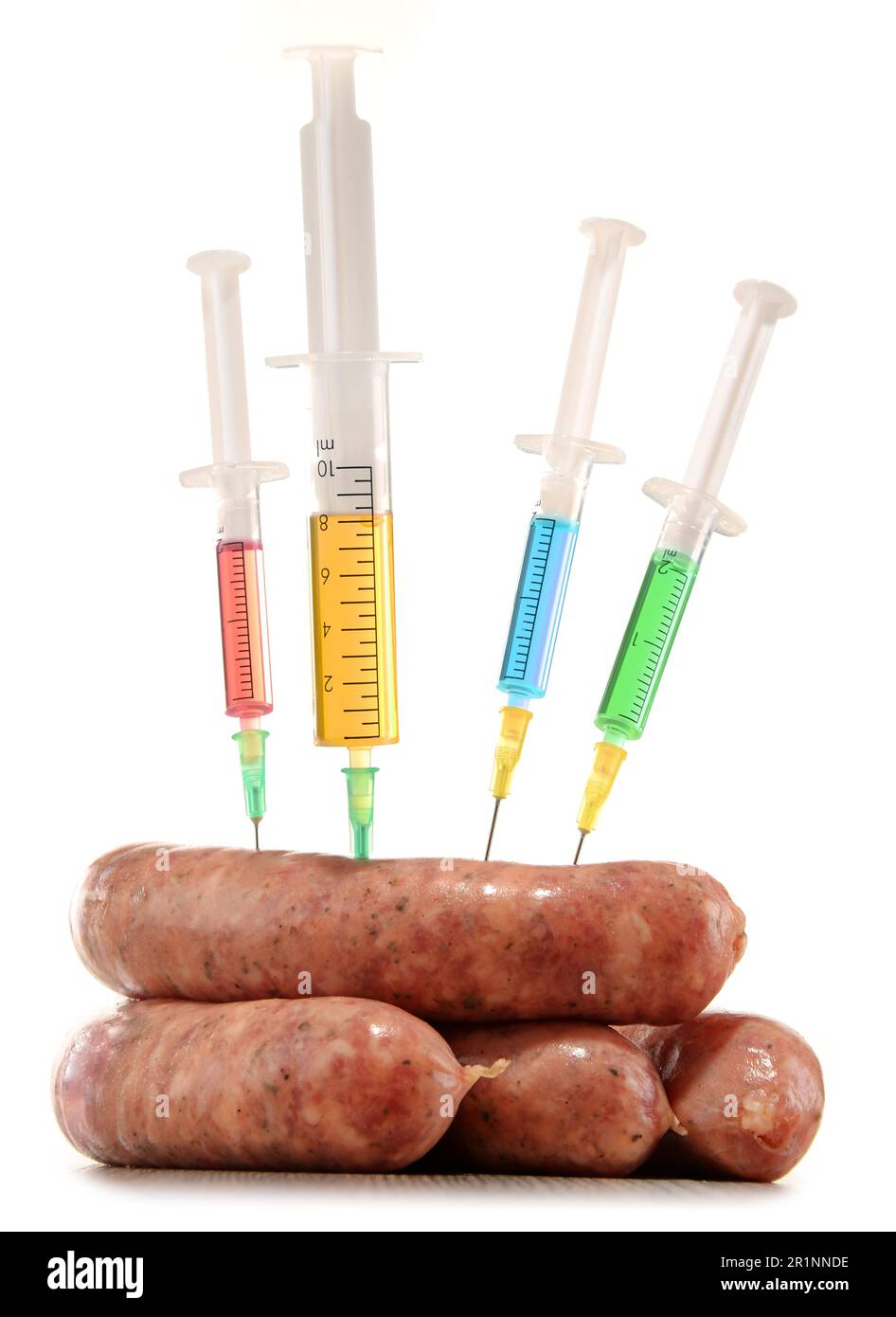 Syringes and meat isolated on white. Genetically modified food. GMO ...