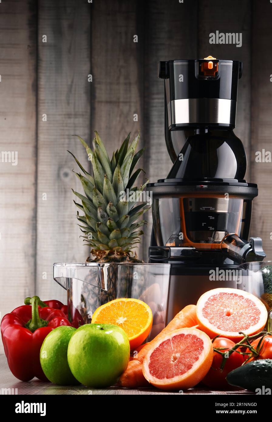 Slow juicer with organic fruits and vegetables. Detox diet Stock Photo ...