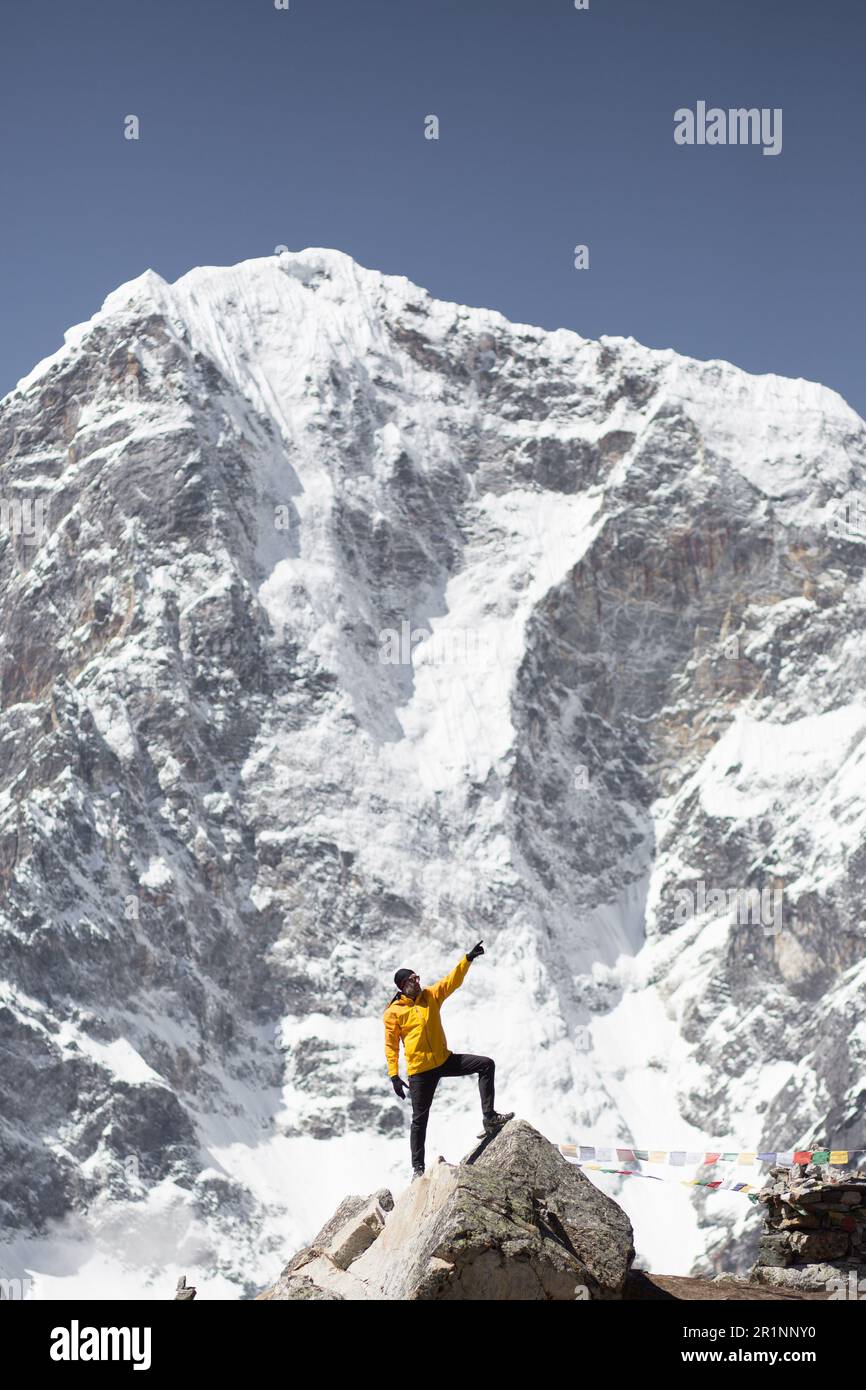A man poses under the mountains on the Everest Base Camp Trek Stock ...