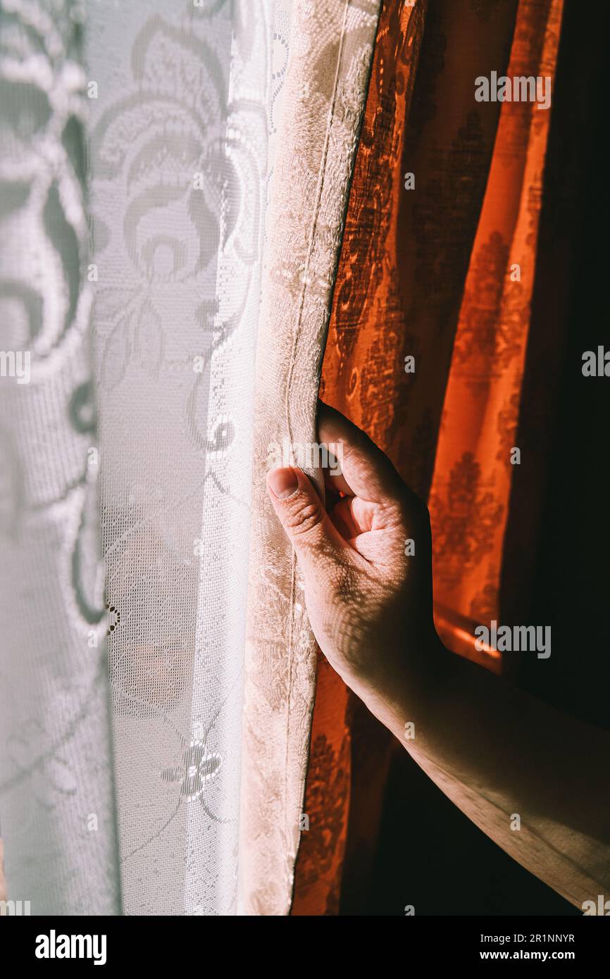 Hand closes the curtain Stock Photo - Alamy