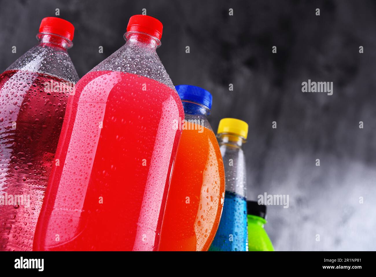 Plastic bottles of assorted carbonated soft drinks in variety of colors ...