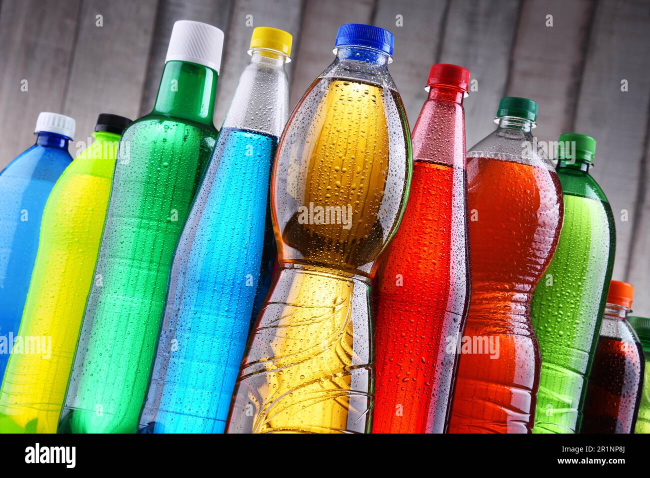 Plastic bottles of assorted carbonated soft drinks in variety of colors ...