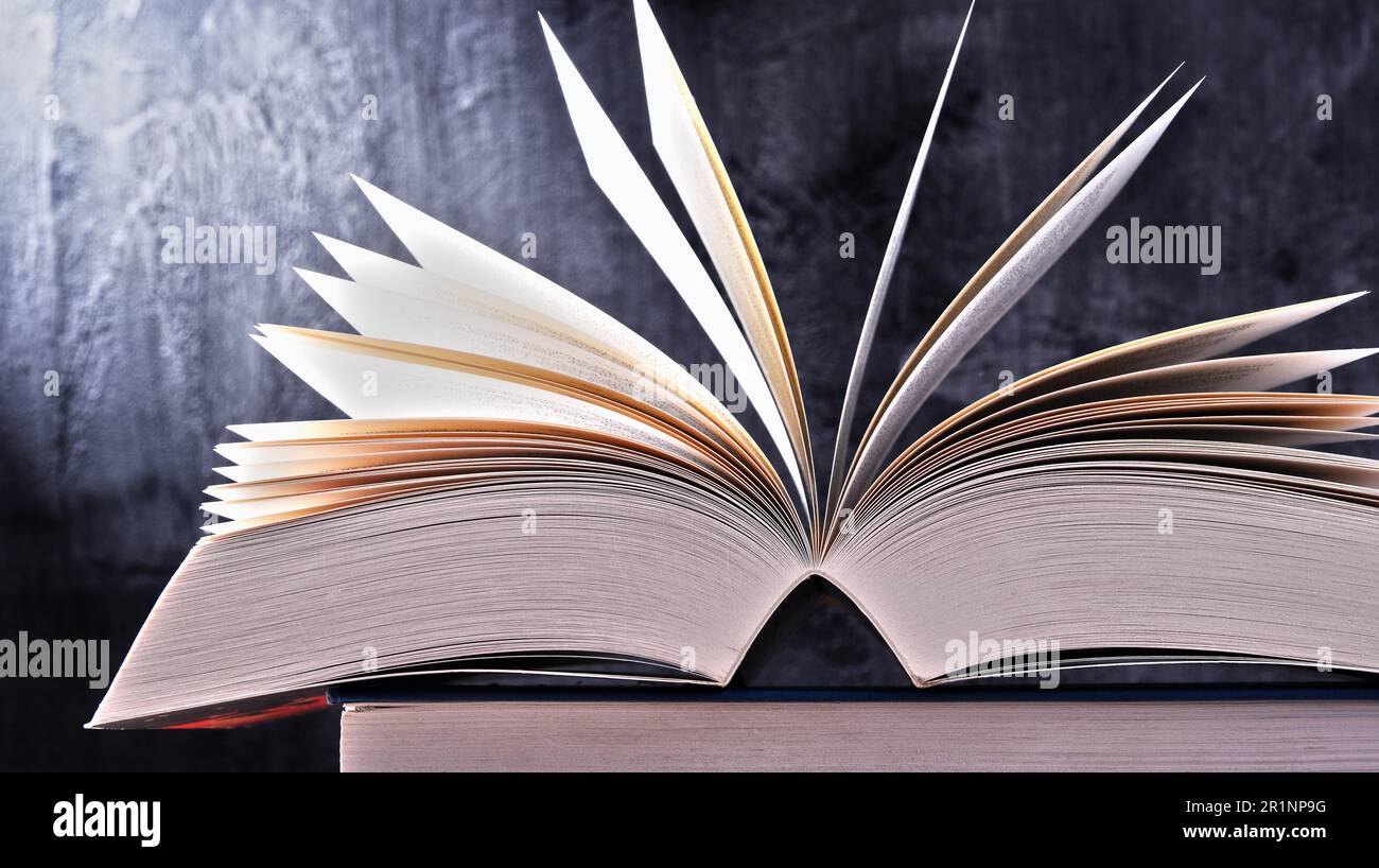 Composition with open book Stock Photo - Alamy
