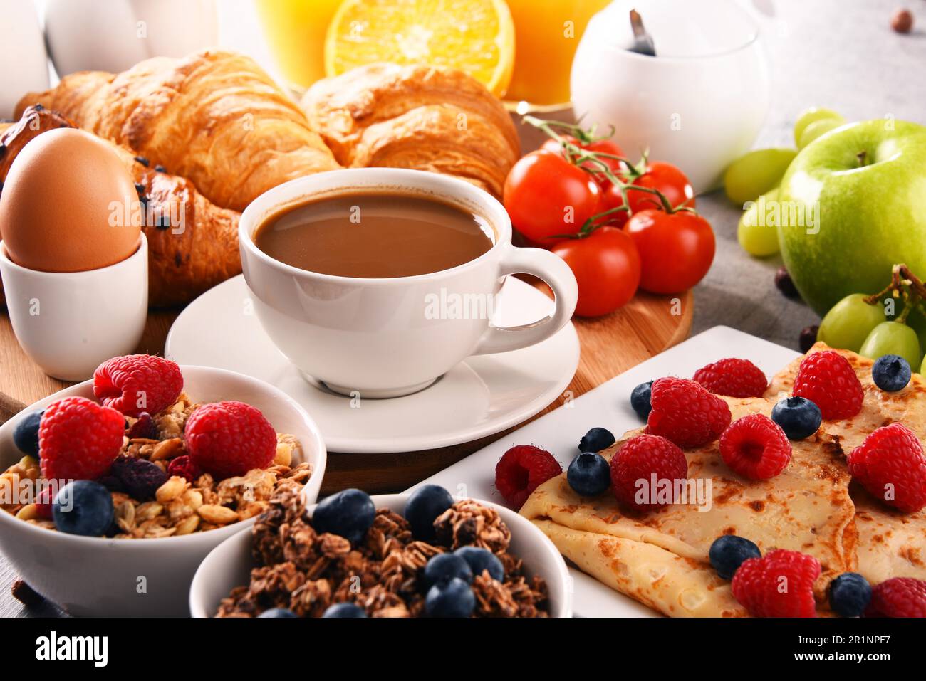 Breakfast served with coffee, orange juice, croissants, egg, cereals ...