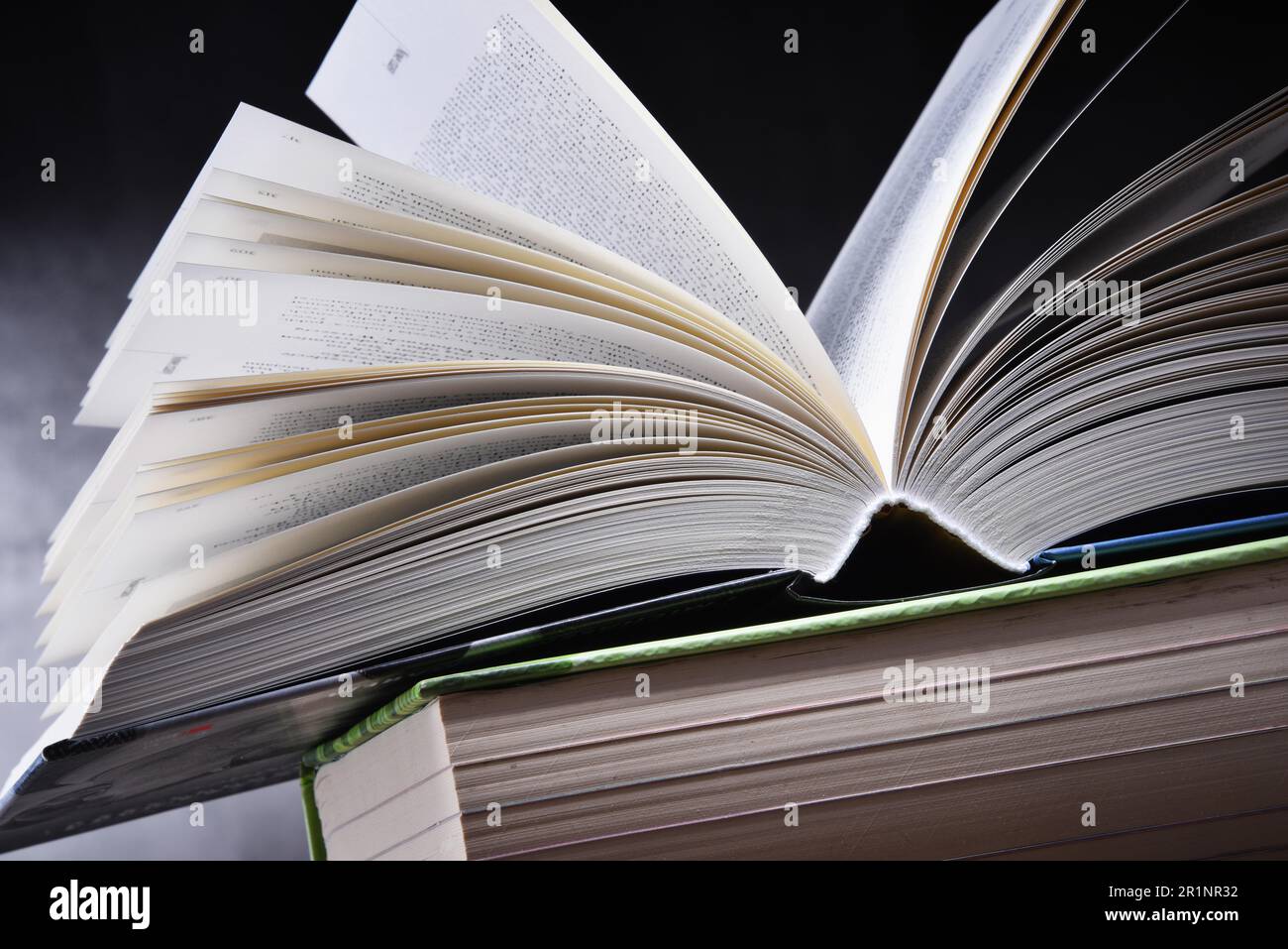 Composition with open book on the table Stock Photo - Alamy