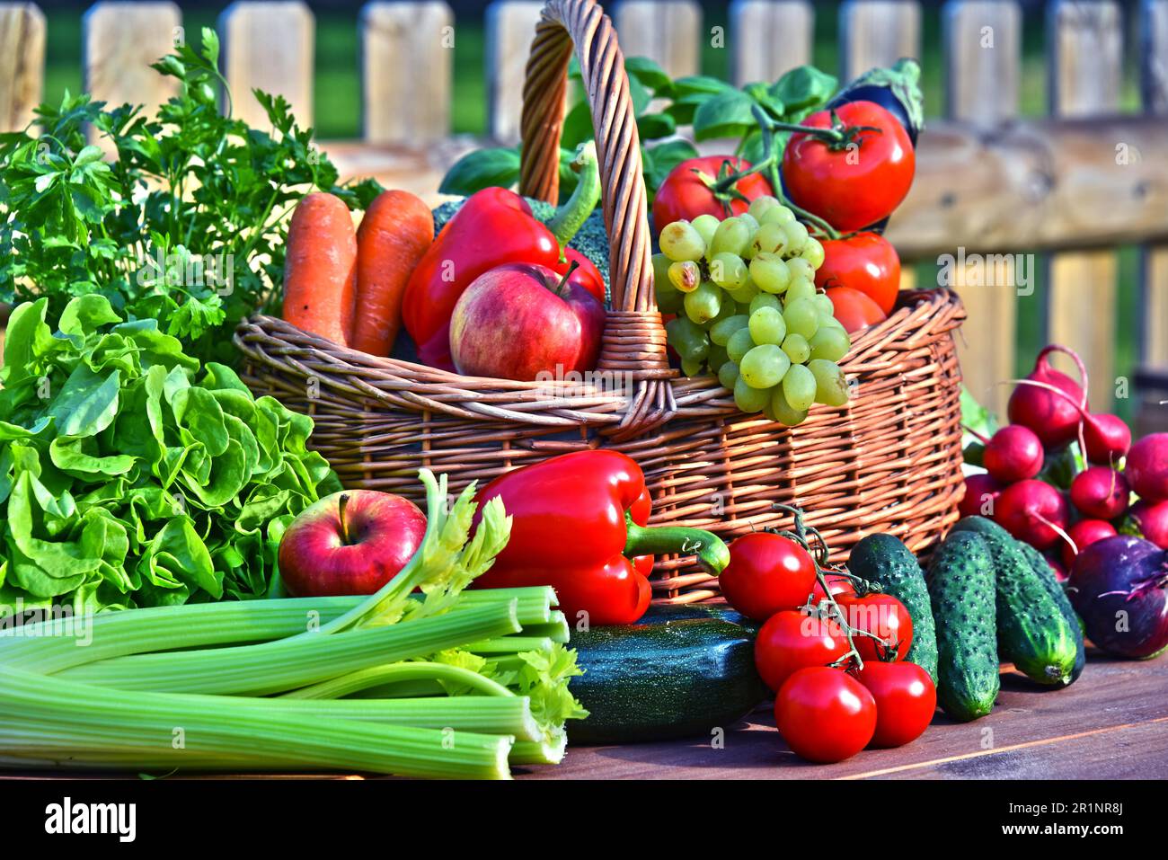 Variety of fresh organic vegetables in wicker basket Stock Photo - Alamy
