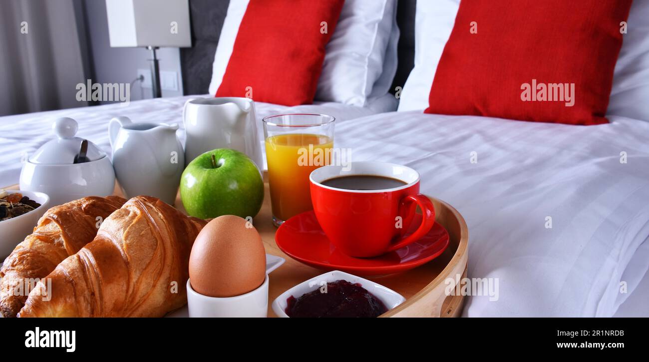 Breakfast on tray in bed in hotel room Stock Photo - Alamy