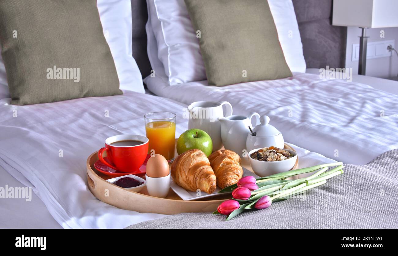 Breakfast on tray in bed in hotel room Stock Photo - Alamy