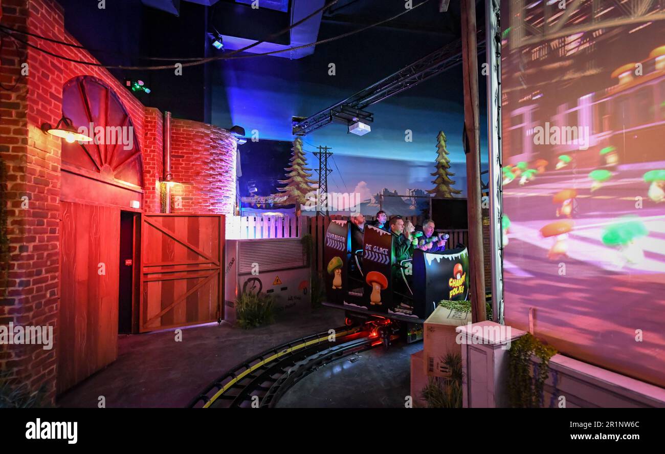 People try out the "Champi'folies' dark ride at Le Pal in France Stock ...
