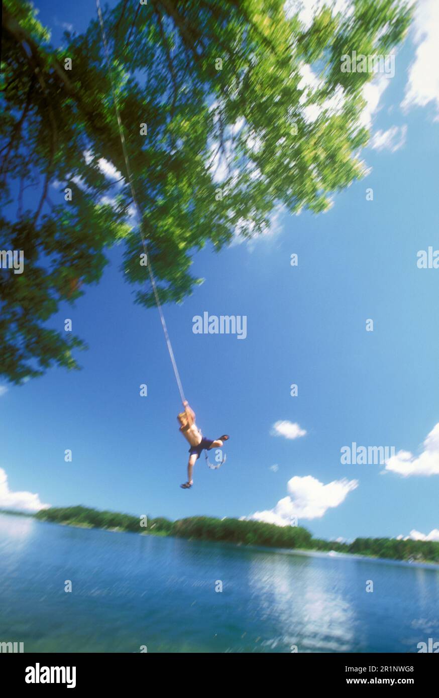 A boy on a rope swing Stock Photo - Alamy