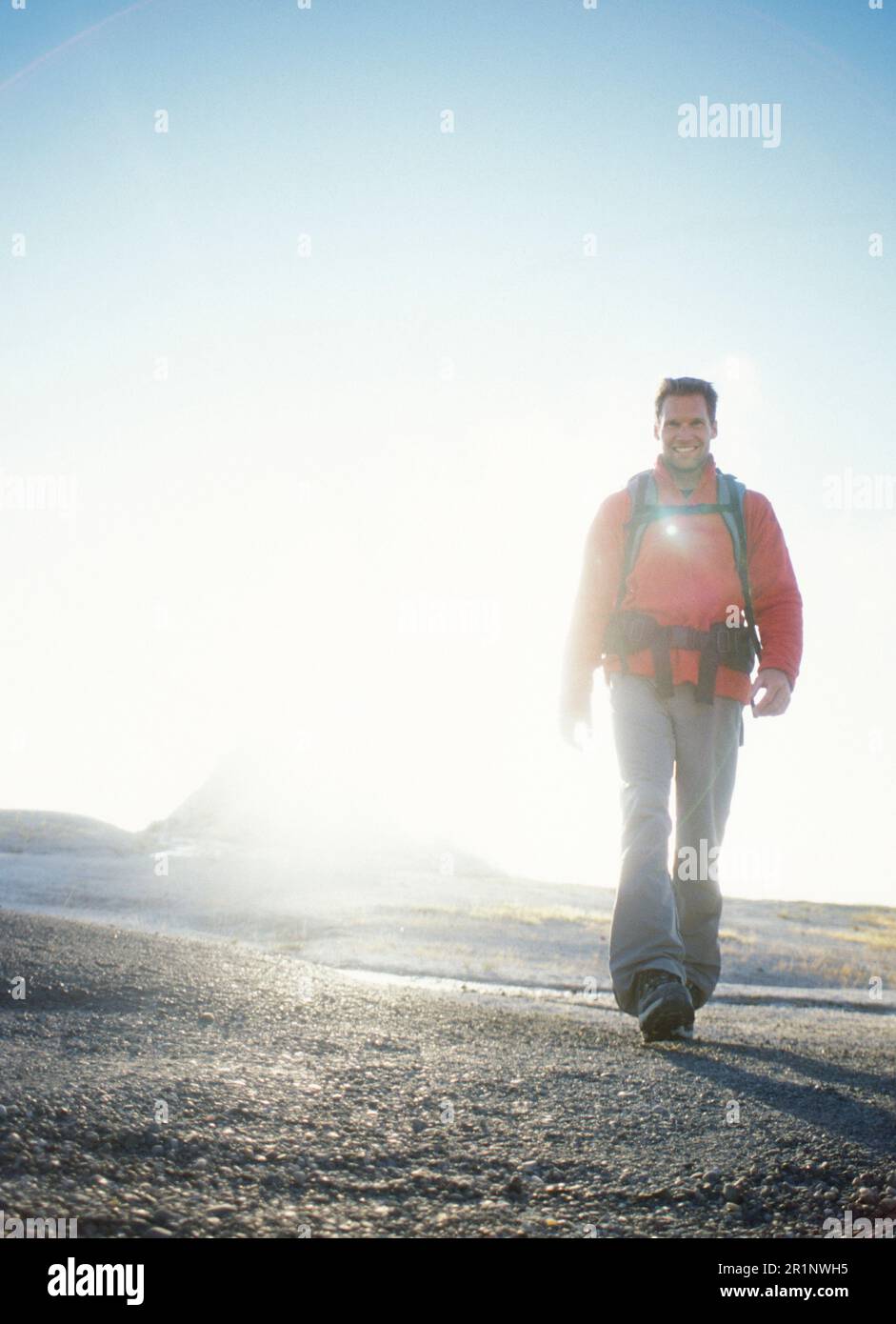 Man hiking in front of Geyser Stock Photo - Alamy