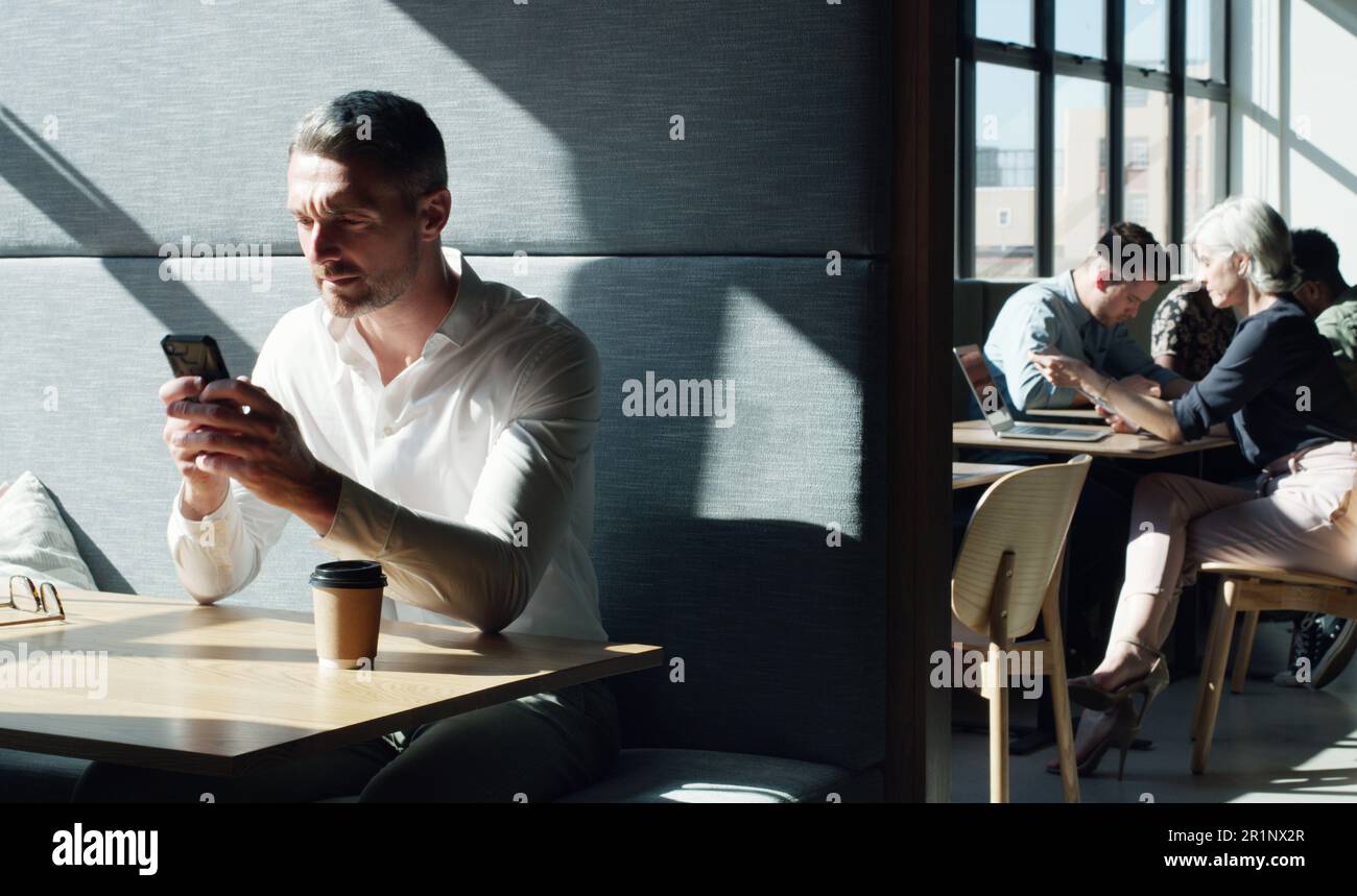 Availability is key. a mature businessman using a smartphone in a ...