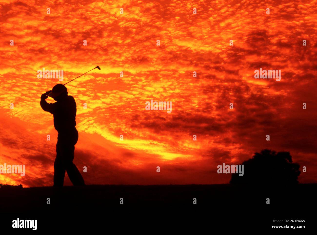 Graphic of golfer and beautiful colored sunset with dramatic clouds ...