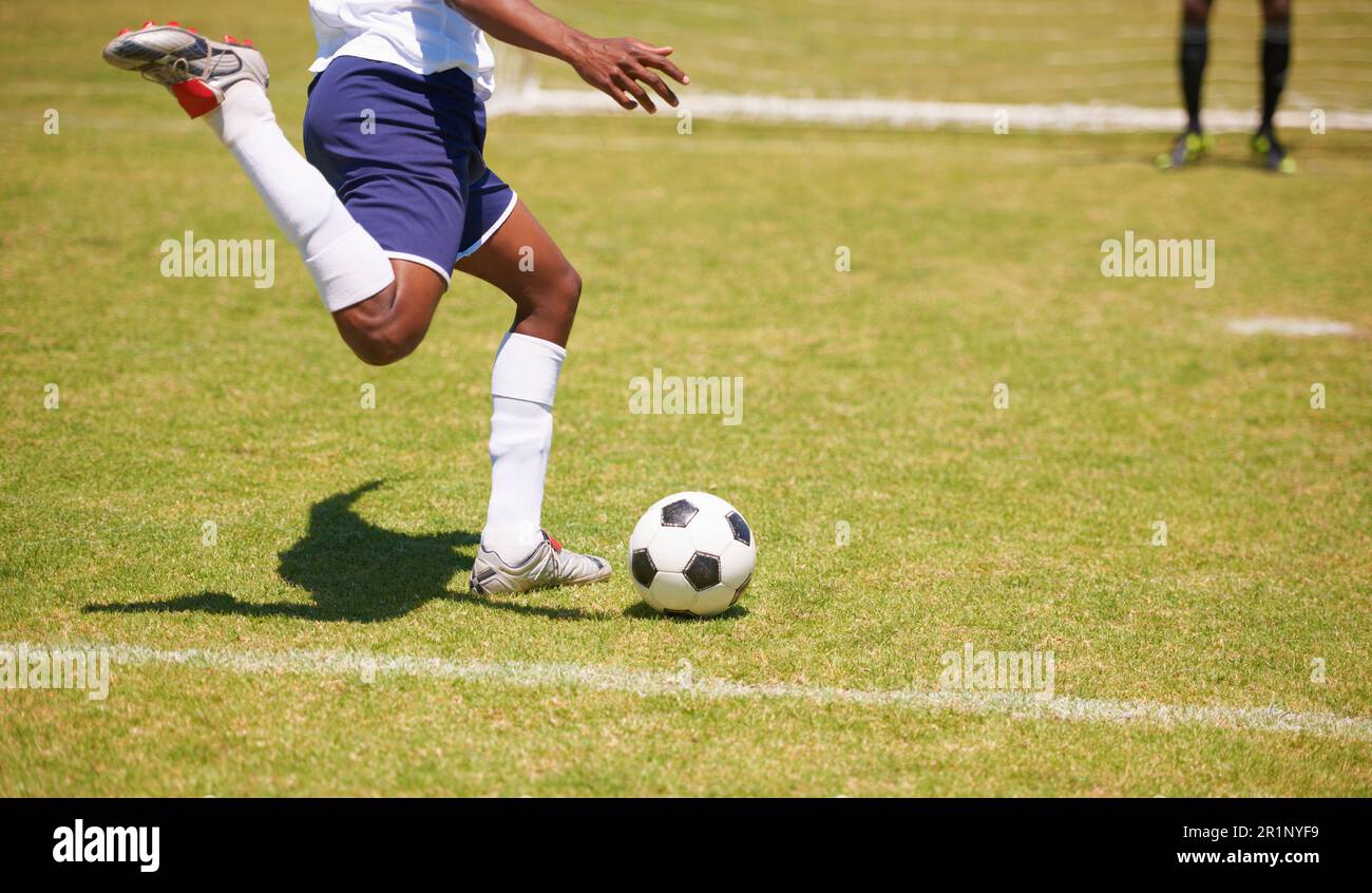 Feet, soccer player and penalty kick on field for goal, competition or ...