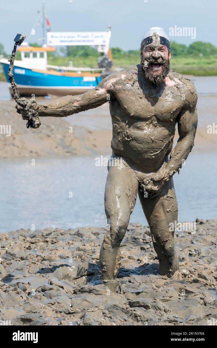 Joel Hicks taking part in the Maldon Mud Race in Maldon, Essex, UK, in the mud of the River ...