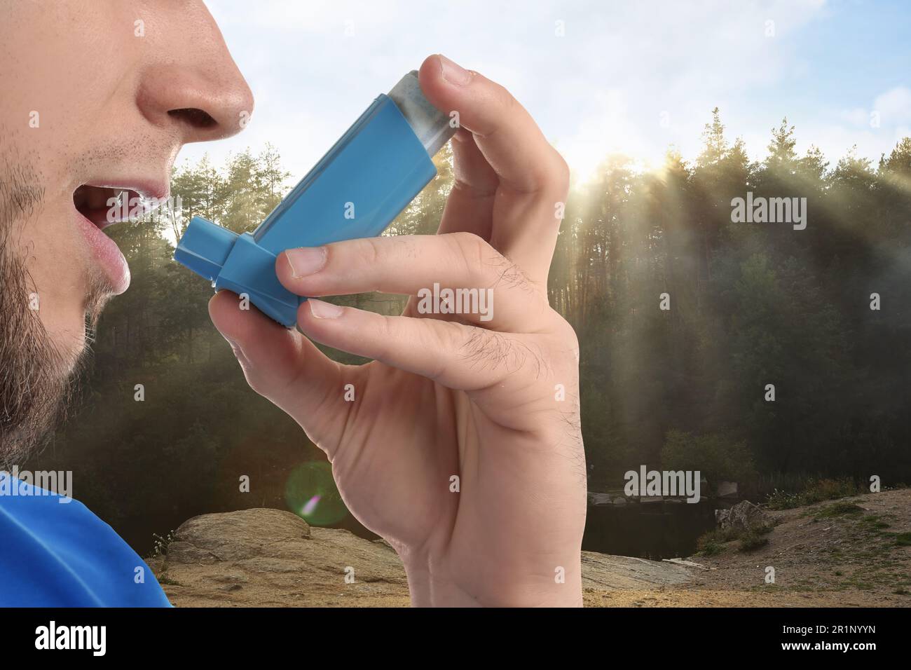 Man using asthma inhaler near forest, closeup. Emergency first aid ...