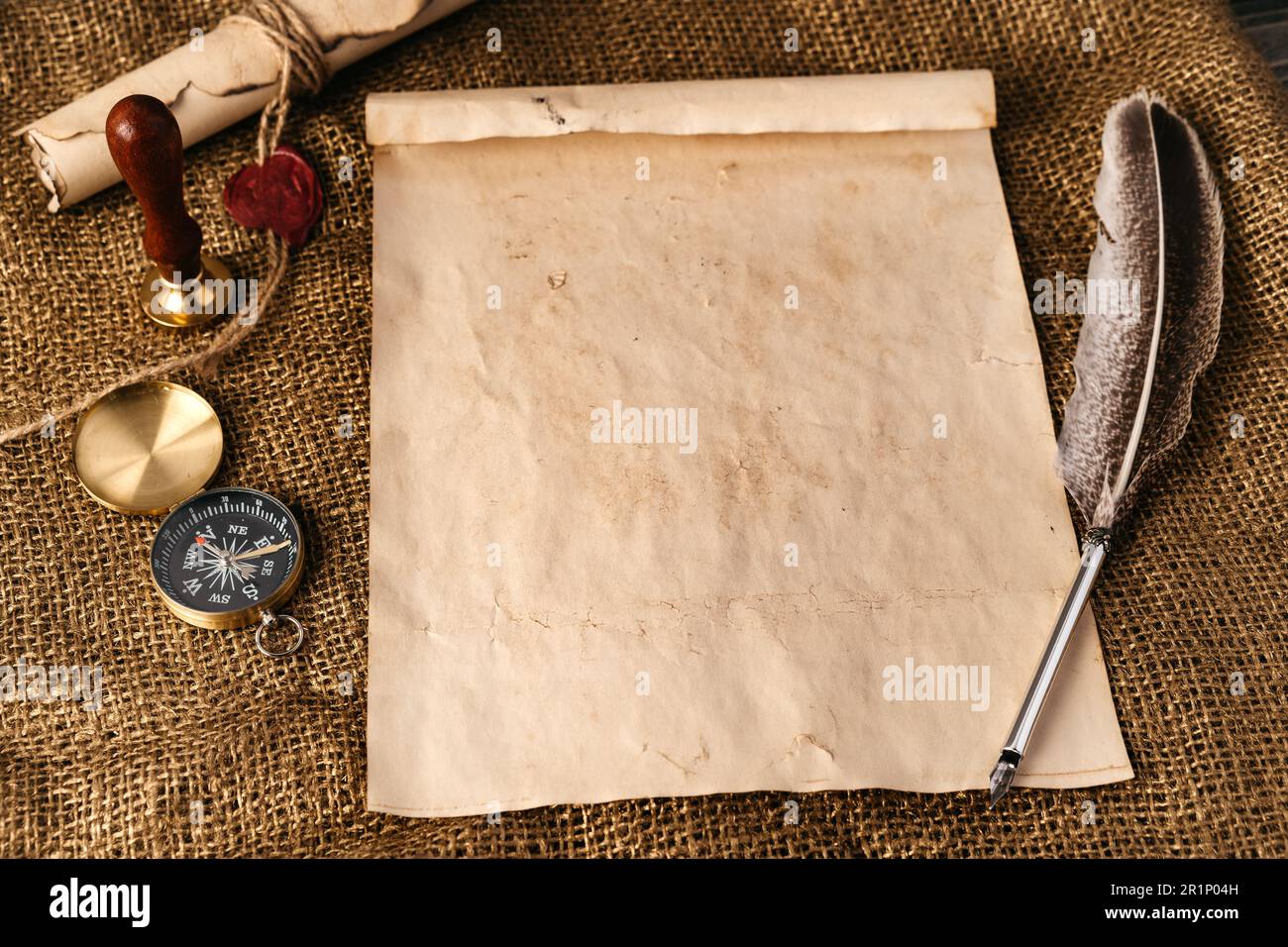 Old paper with compass and quill pen top view Stock Photo - Alamy