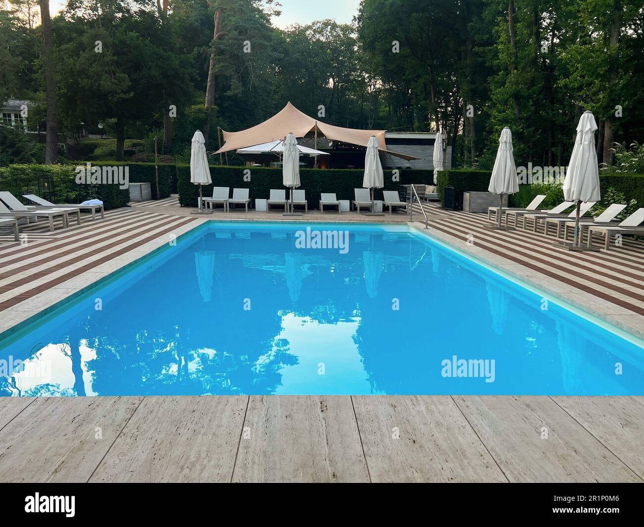Outdoor swimming pool in luxury hotel on sunny summer day. Time for ...