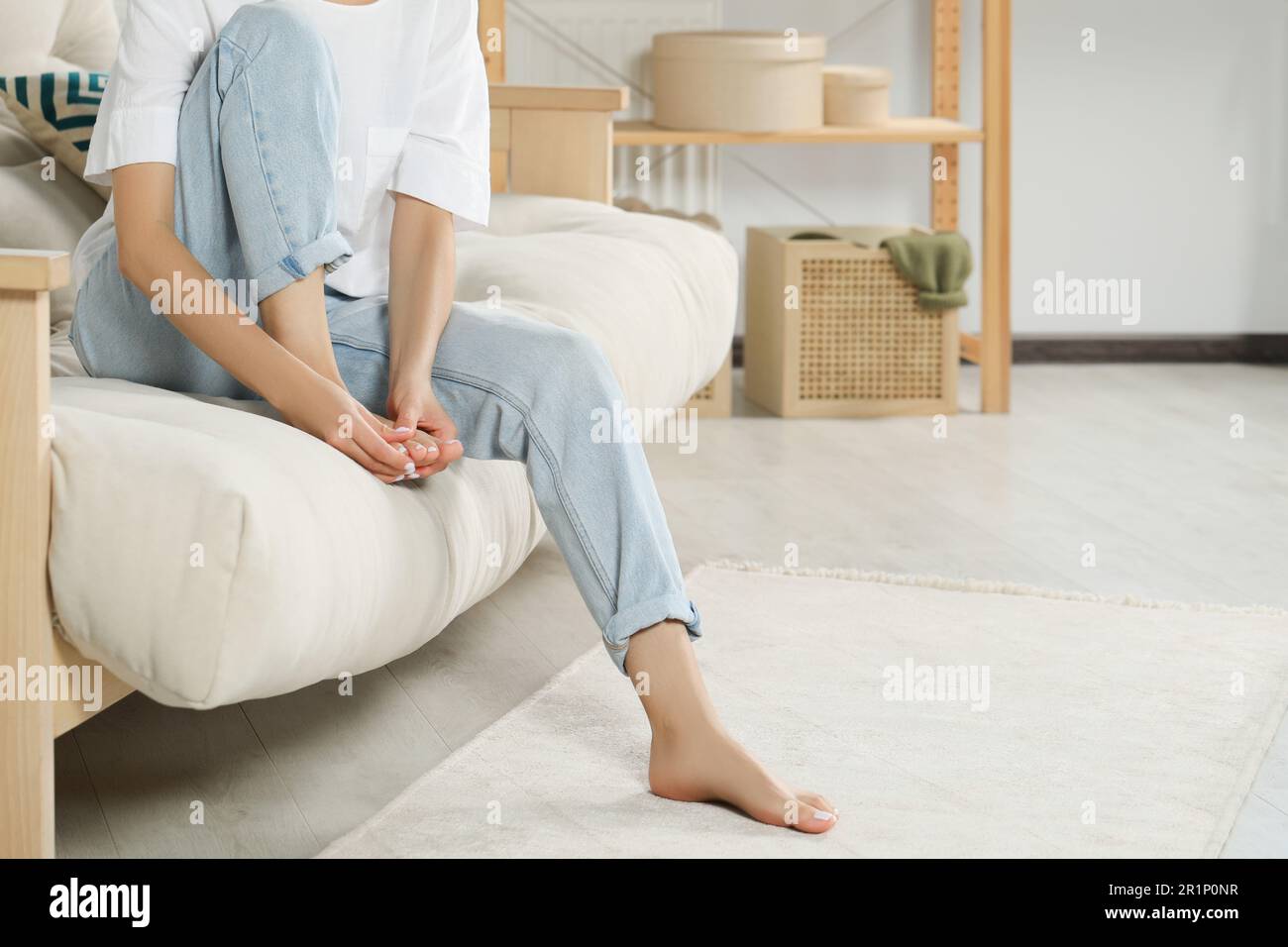 Woman sore legs couch hi-res stock photography and images - Alamy