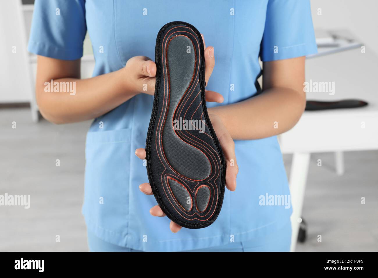 Female orthopedist showing insole in hospital, closeup Stock Photo - Alamy