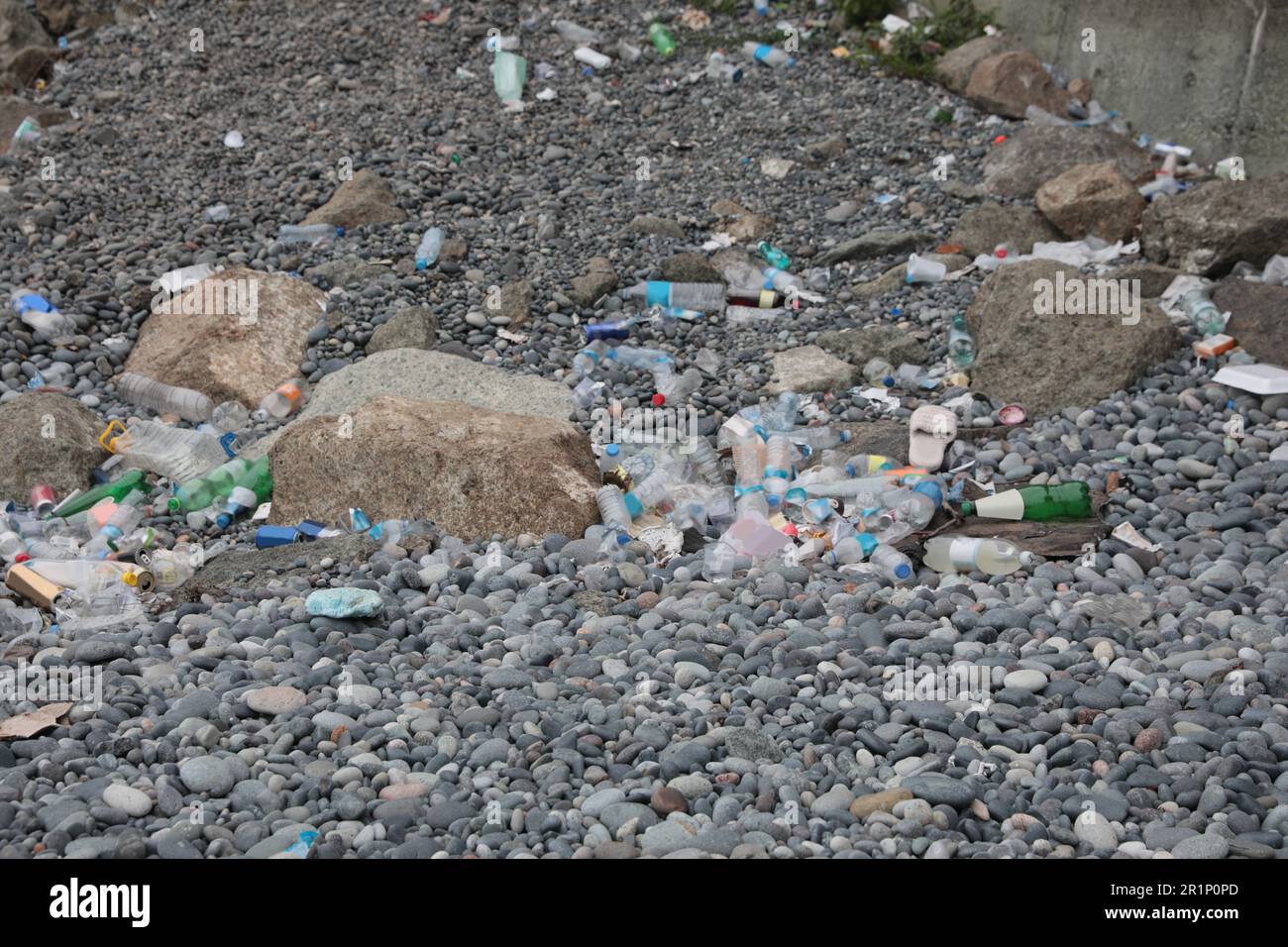 Garbage scattered on pebbles outdoors. Recycling problem Stock Photo ...