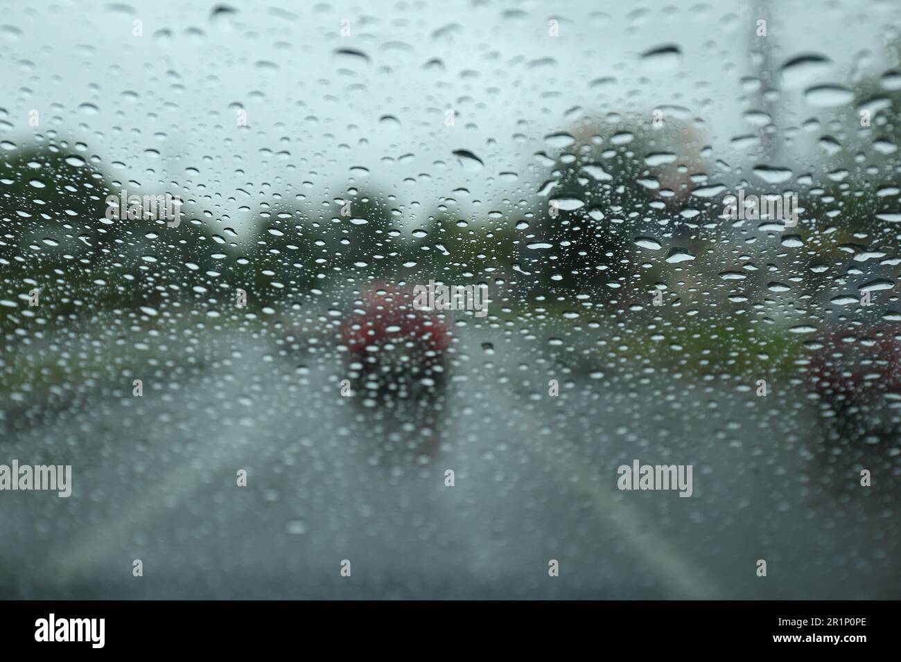 Blurred view of road through wet car window. Rainy weather Stock Photo ...