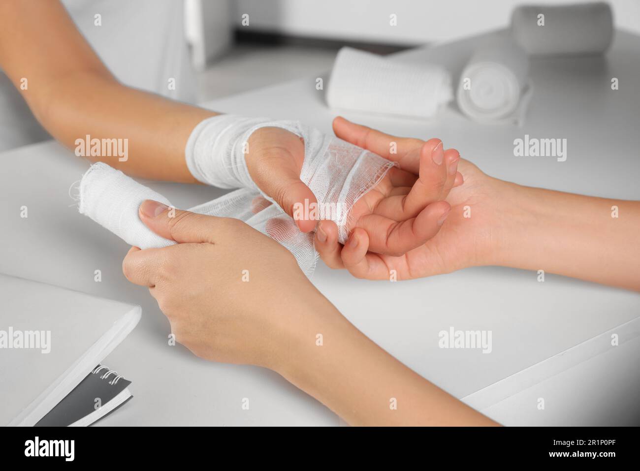 Doctor applying bandage onto patient's hand in hospital, closeup Stock ...