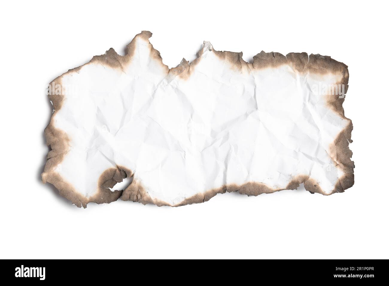 Piece of crumpled paper with dark burnt borders on white background ...