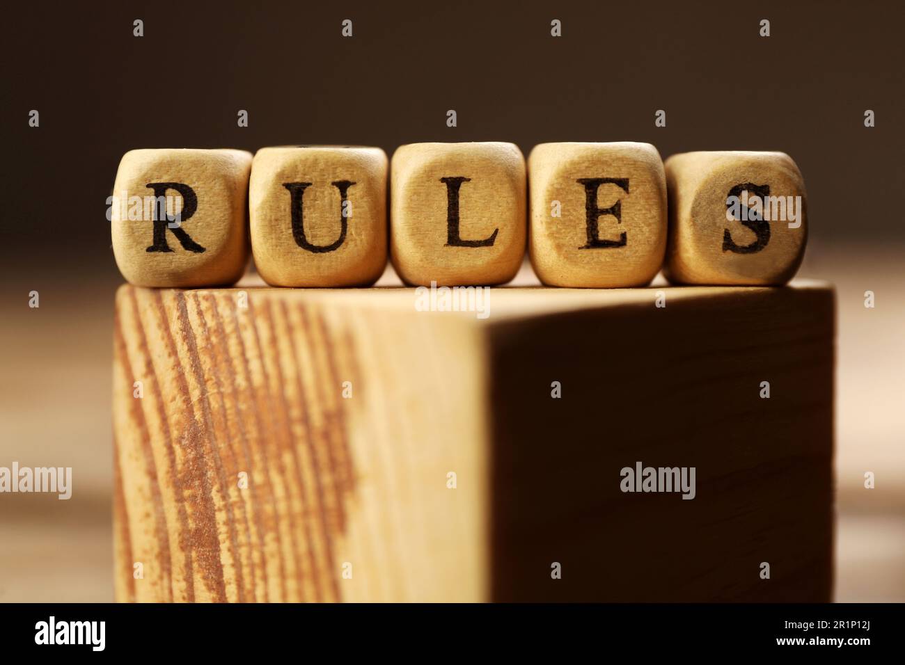 Word Rules made of cubes with letters on wooden block, closeup Stock ...