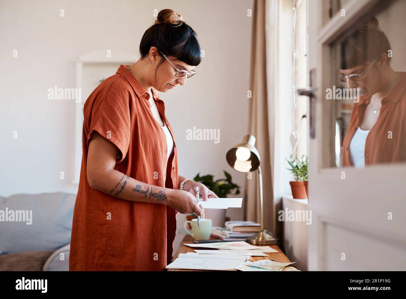 Gathering ideas for a new design. a an artist looking at her sketches ...