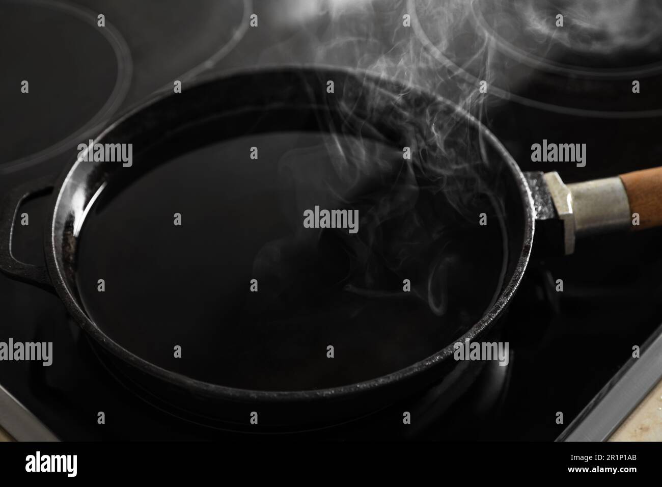 Frying pan with hot used cooking oil on stove, closeup Stock Photo - Alamy